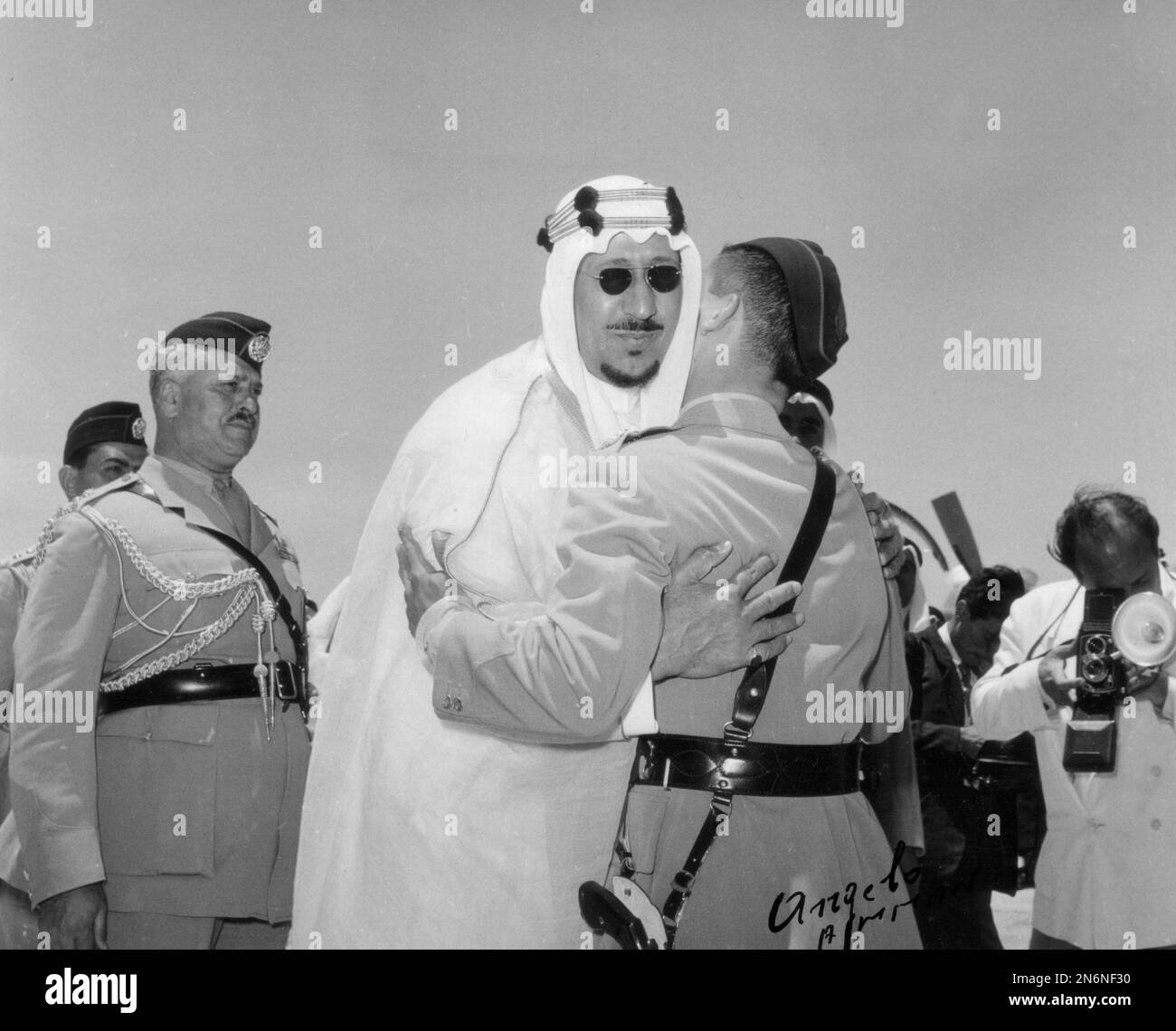 King Hussein of Jordan (back to camera) embraces his guest King Saud of ...