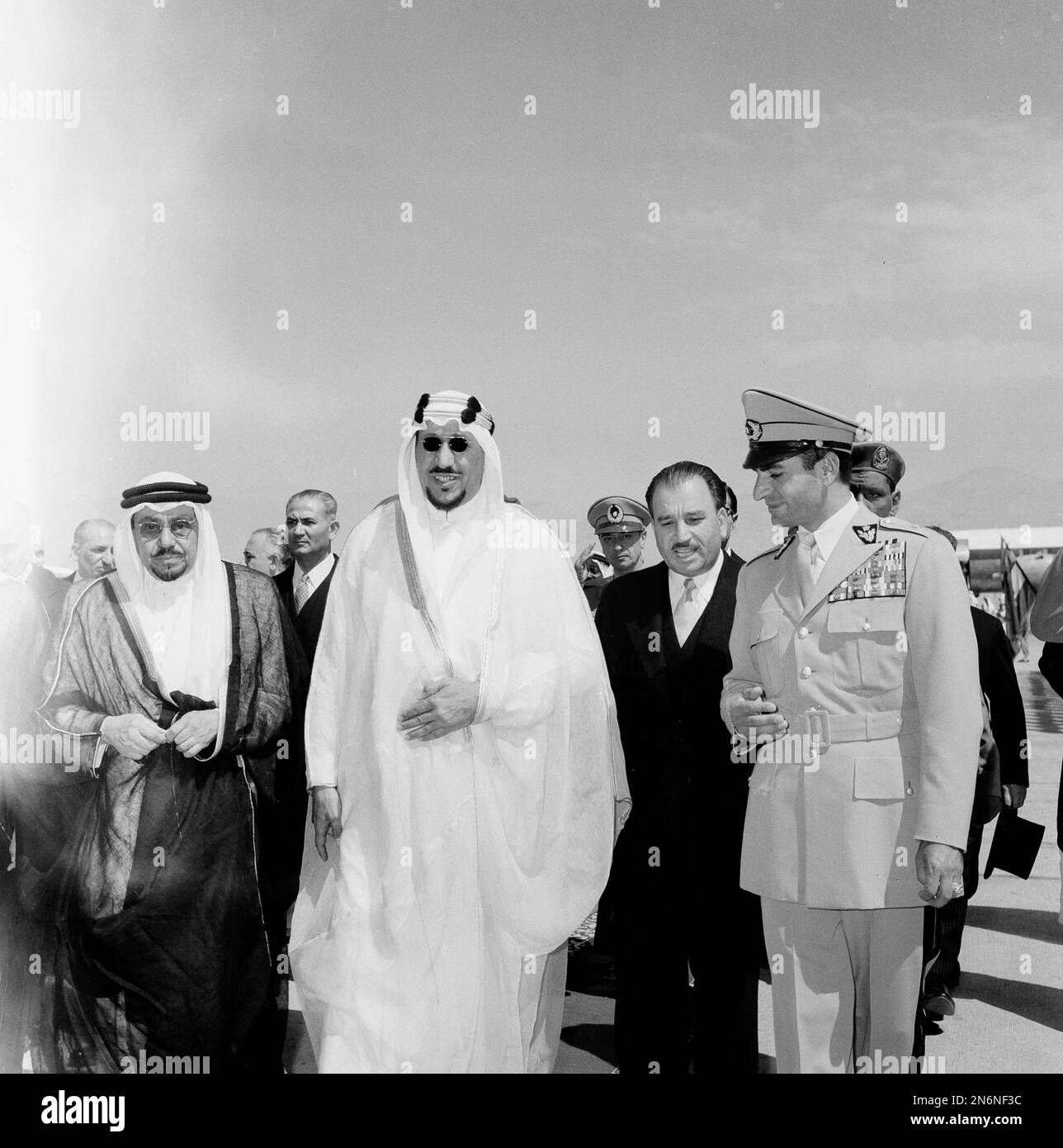 King Saud of Saudi Arabia (center) arrives by air at Tehran on August 9 ...