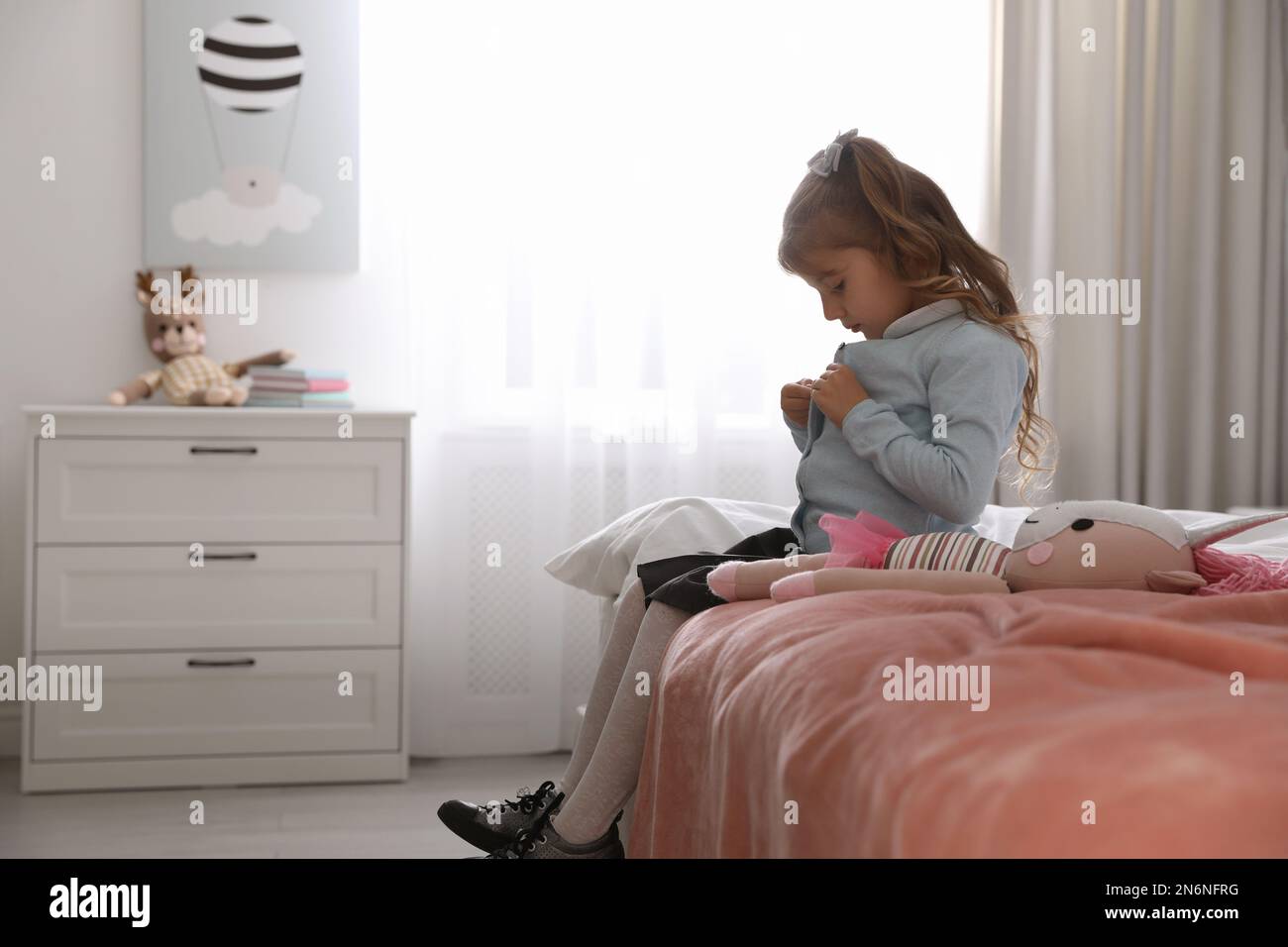 Little girl getting ready for school in bedroom Stock Photo - Alamy