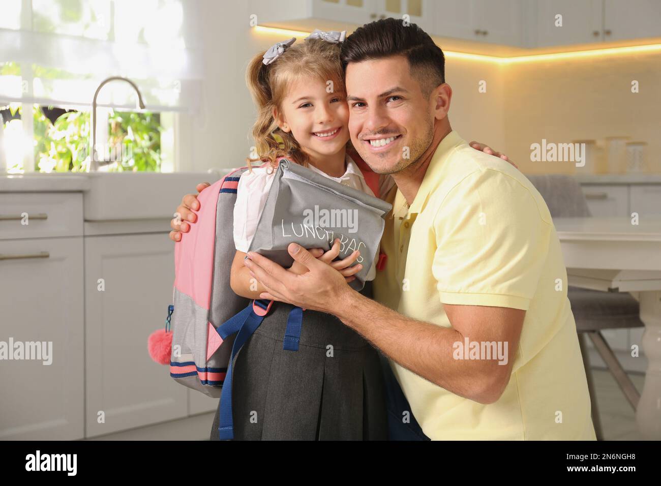 Father helping his little child get ready for school in kitchen Stock ...