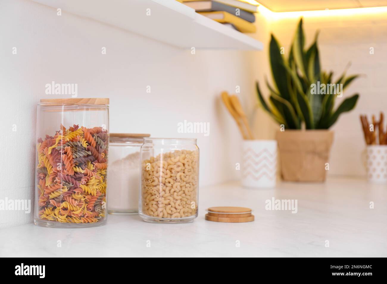 Different types of pasta on counter in modern kitchen Stock Photo - Alamy