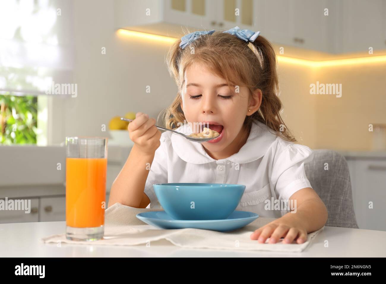 Little girl having breakfast in kitchen. Getting ready for school Stock ...