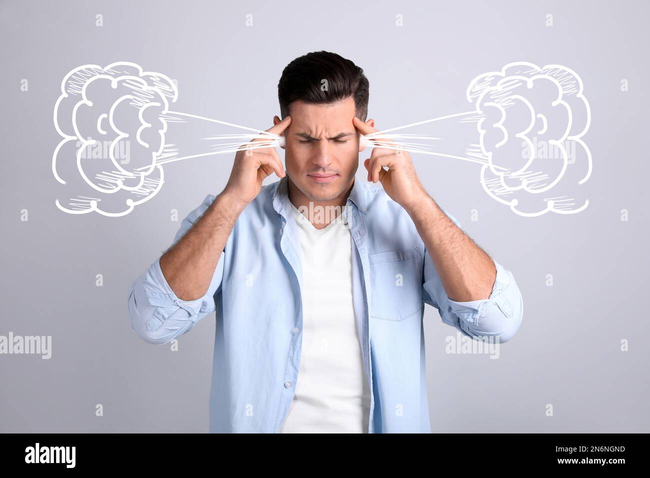 Stressed and upset young man on light grey background Stock Photo - Alamy