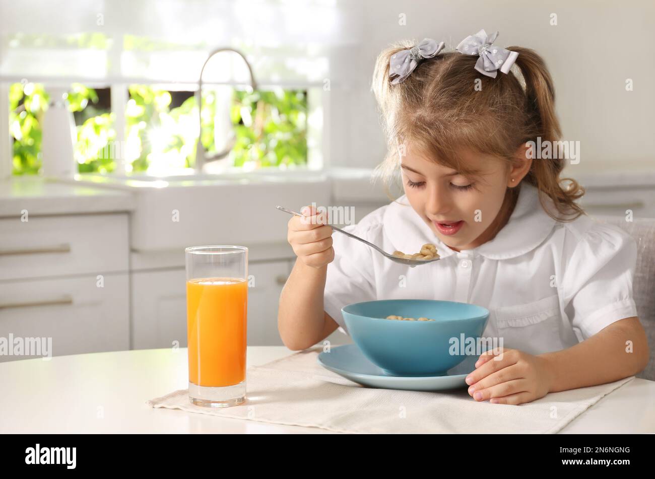 Little girl having breakfast in kitchen. Getting ready for school Stock ...