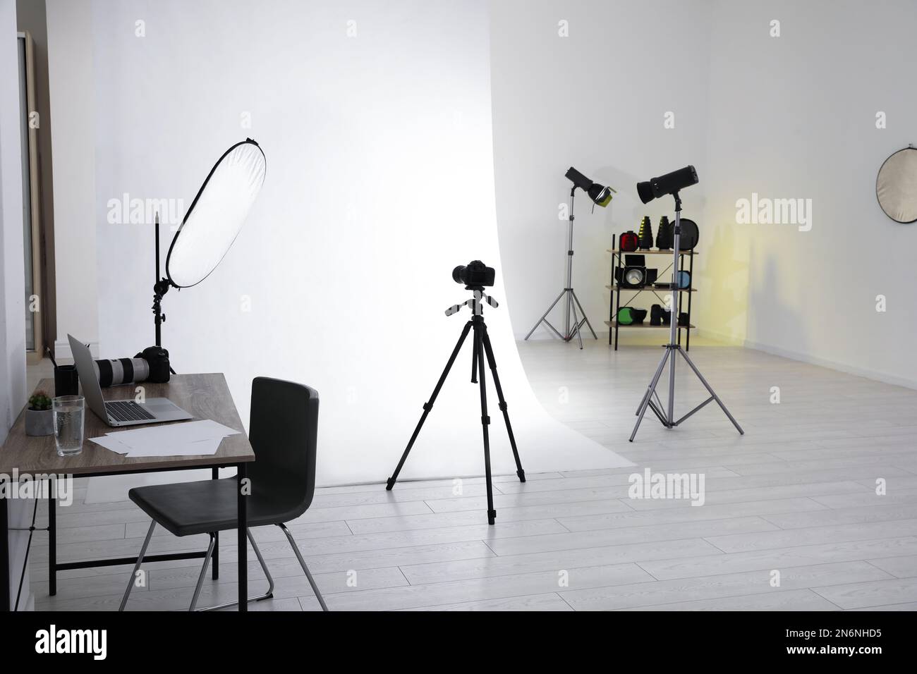 Photo studio interior with set of professional equipment and workplace ...