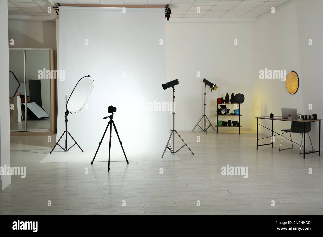 Photo studio interior with set of professional equipment and workplace ...