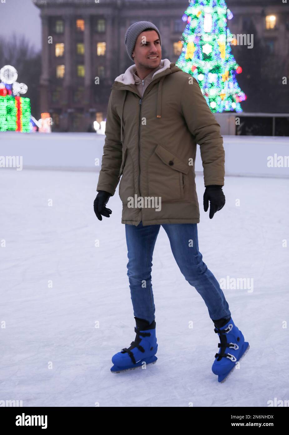 Happy man skating at outdoor ice rink Stock Photo - Alamy