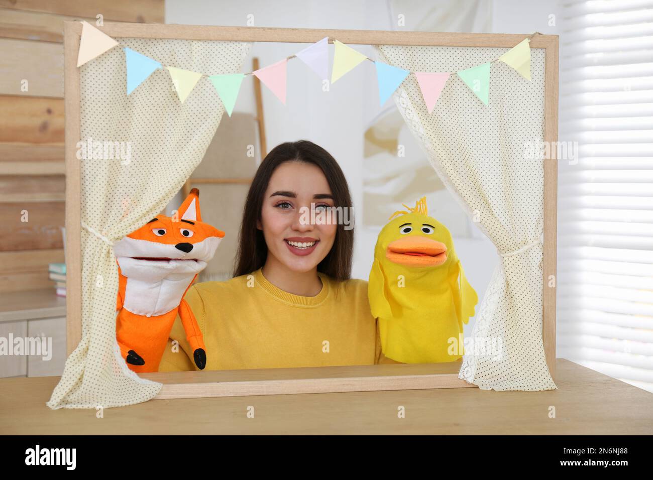 Young woman performing puppet show at home Stock Photo - Alamy