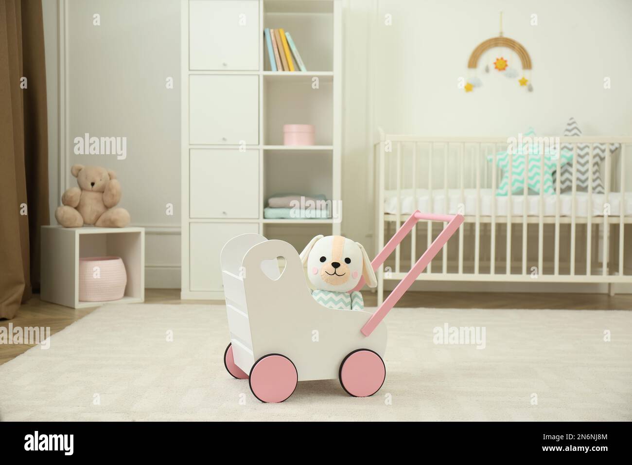 Toy walker with soft dog in baby room. Interior design Stock Photo - Alamy