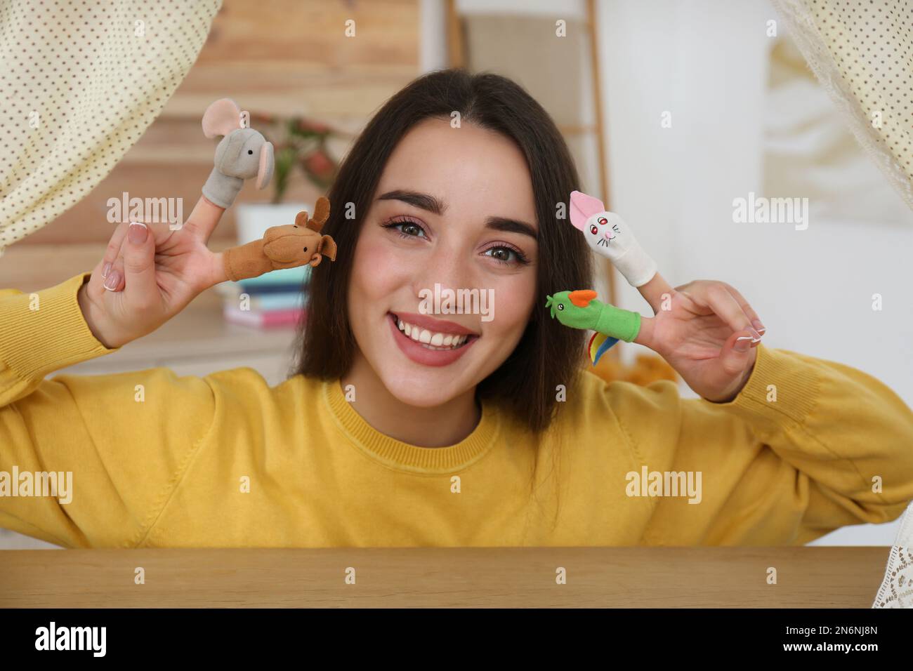 Young woman performing puppet show at home Stock Photo - Alamy