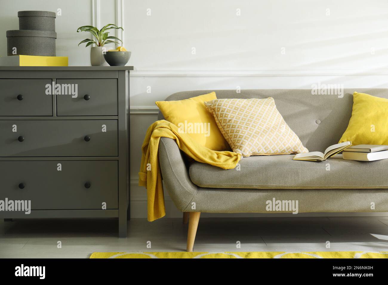 Stylish living room with sofa. Interior design in grey and yellow ...