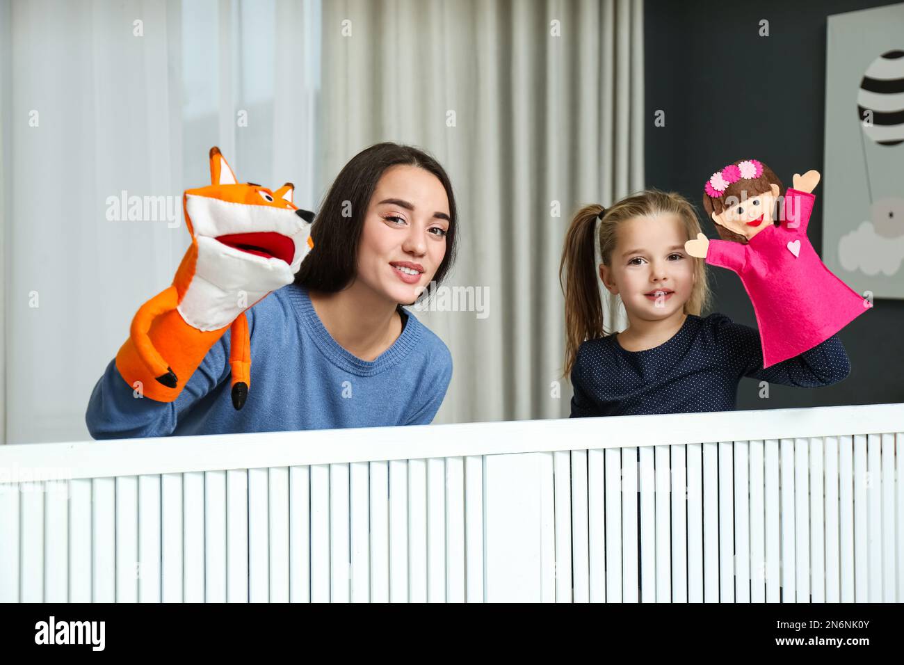 Mother and daughter performing puppet show at home Stock Photo - Alamy