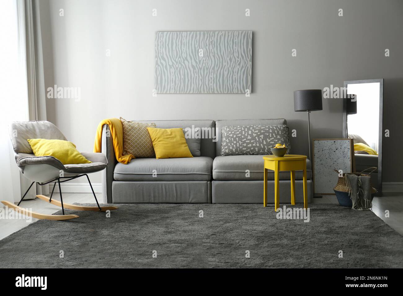 Stylish living room with sofa. Interior design in grey and yellow ...