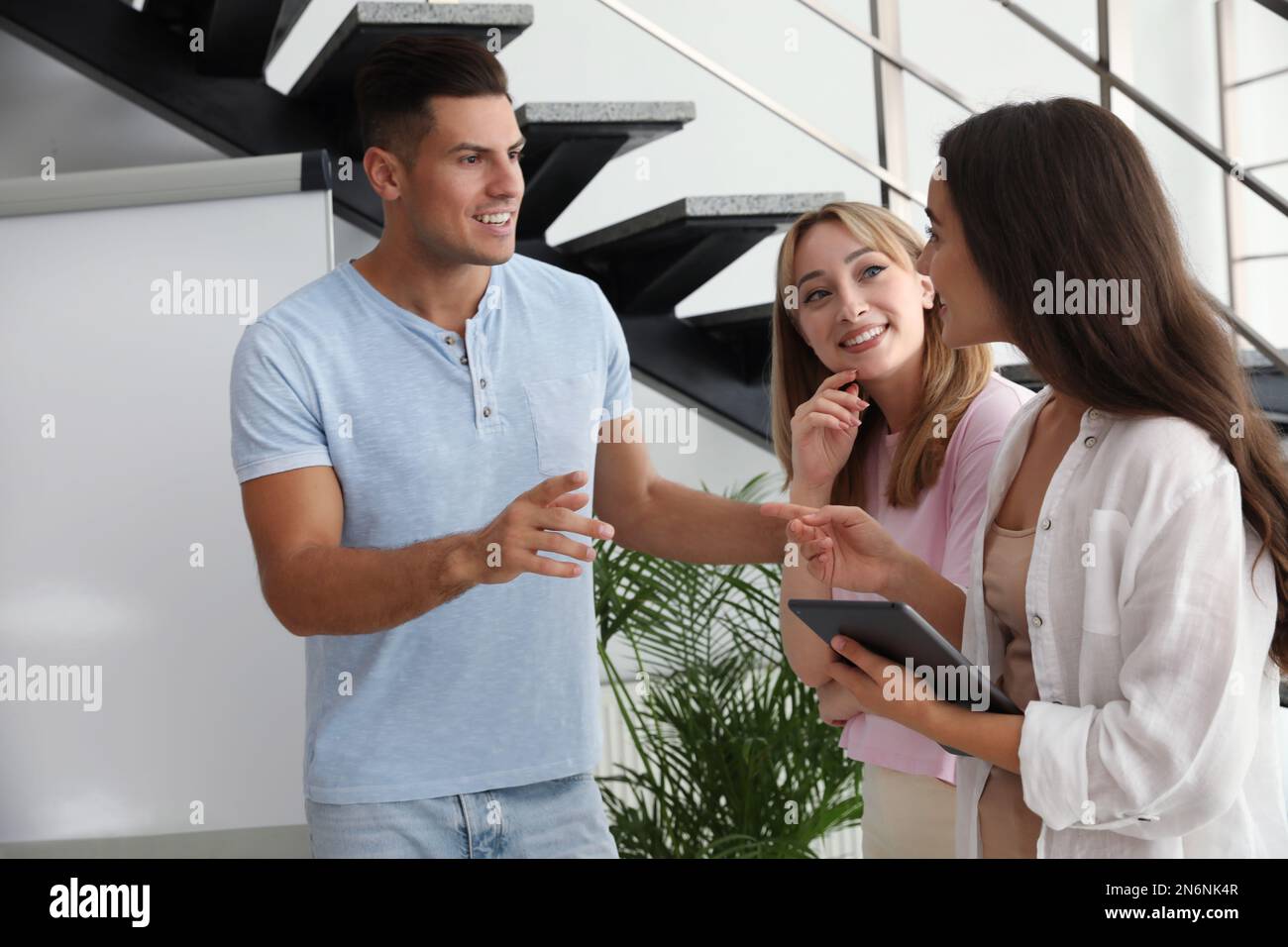 Group of people having conversation in hall Stock Photo - Alamy