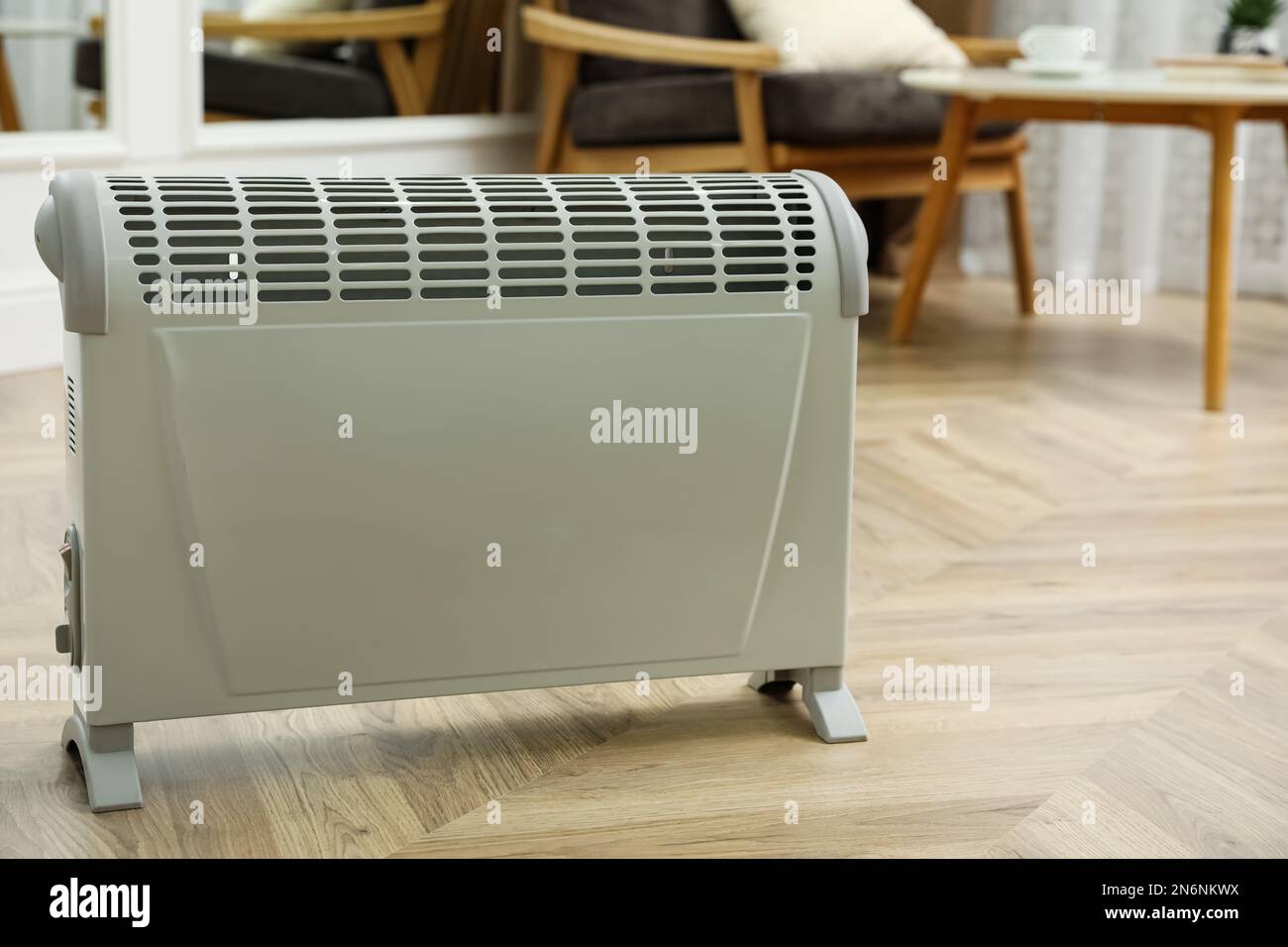 Modern electric convection heater on floor at home Stock Photo - Alamy