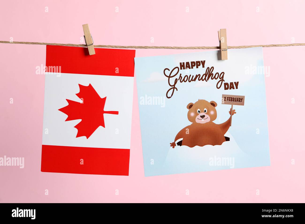 Happy Groundhog Day greeting card and Canada flag hanging on pink ...