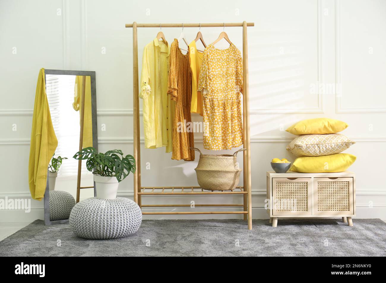 Stylish dressing room with clothes rack. Interior design in grey and ...