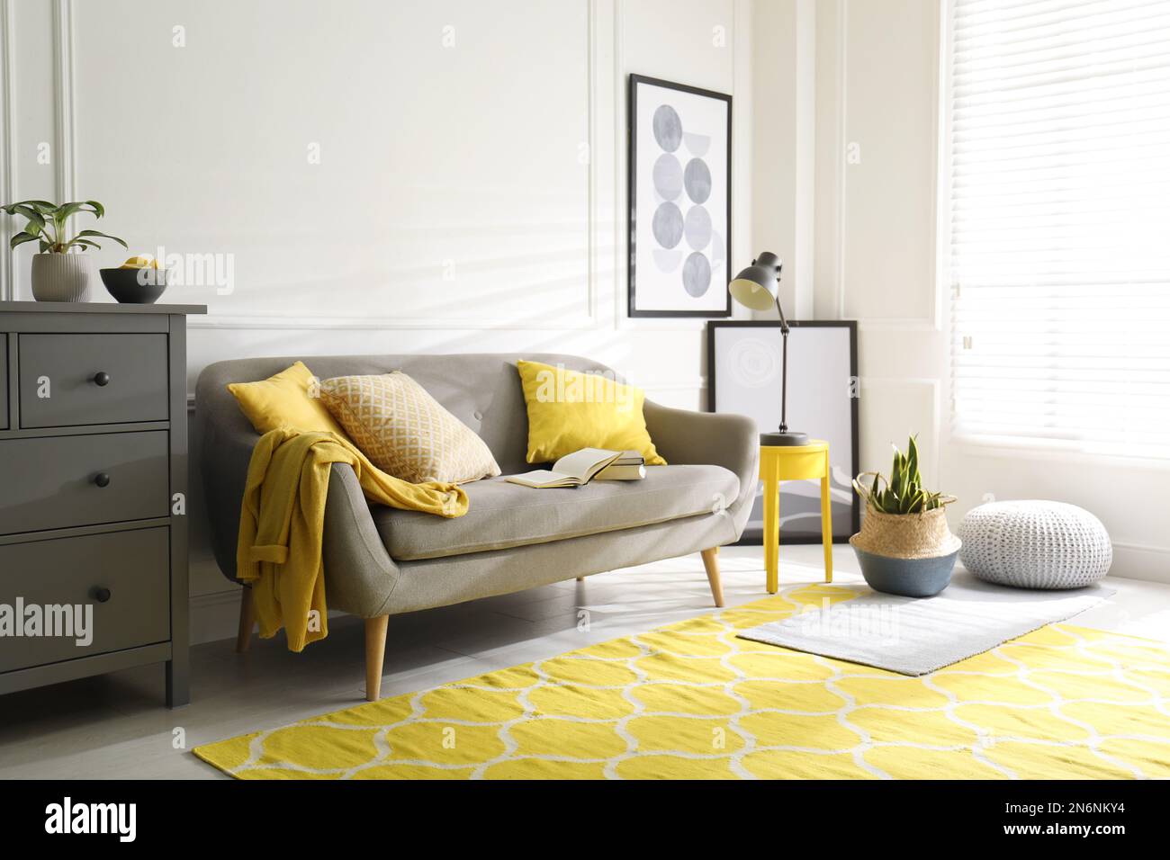 Stylish living room with sofa. Interior design in grey and yellow ...