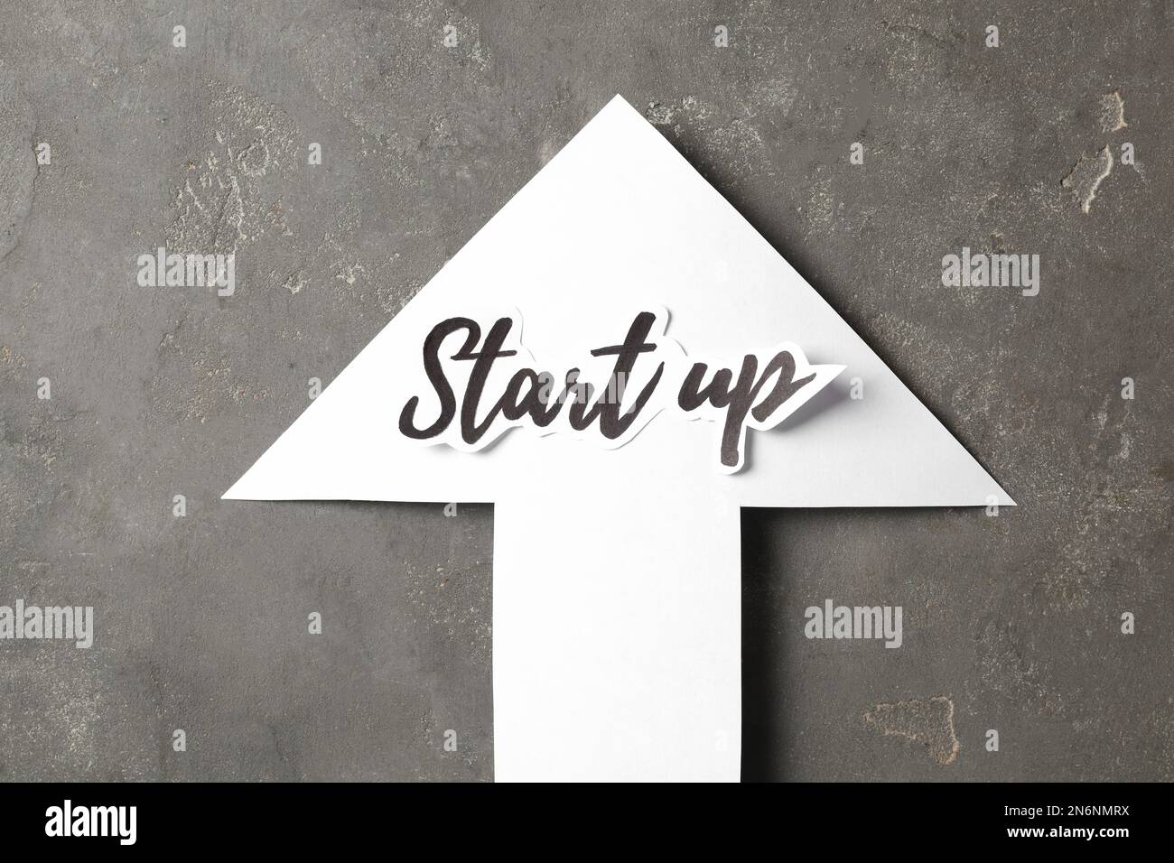 Paper arrow with phrase Start Up on grey table, top view Stock Photo ...