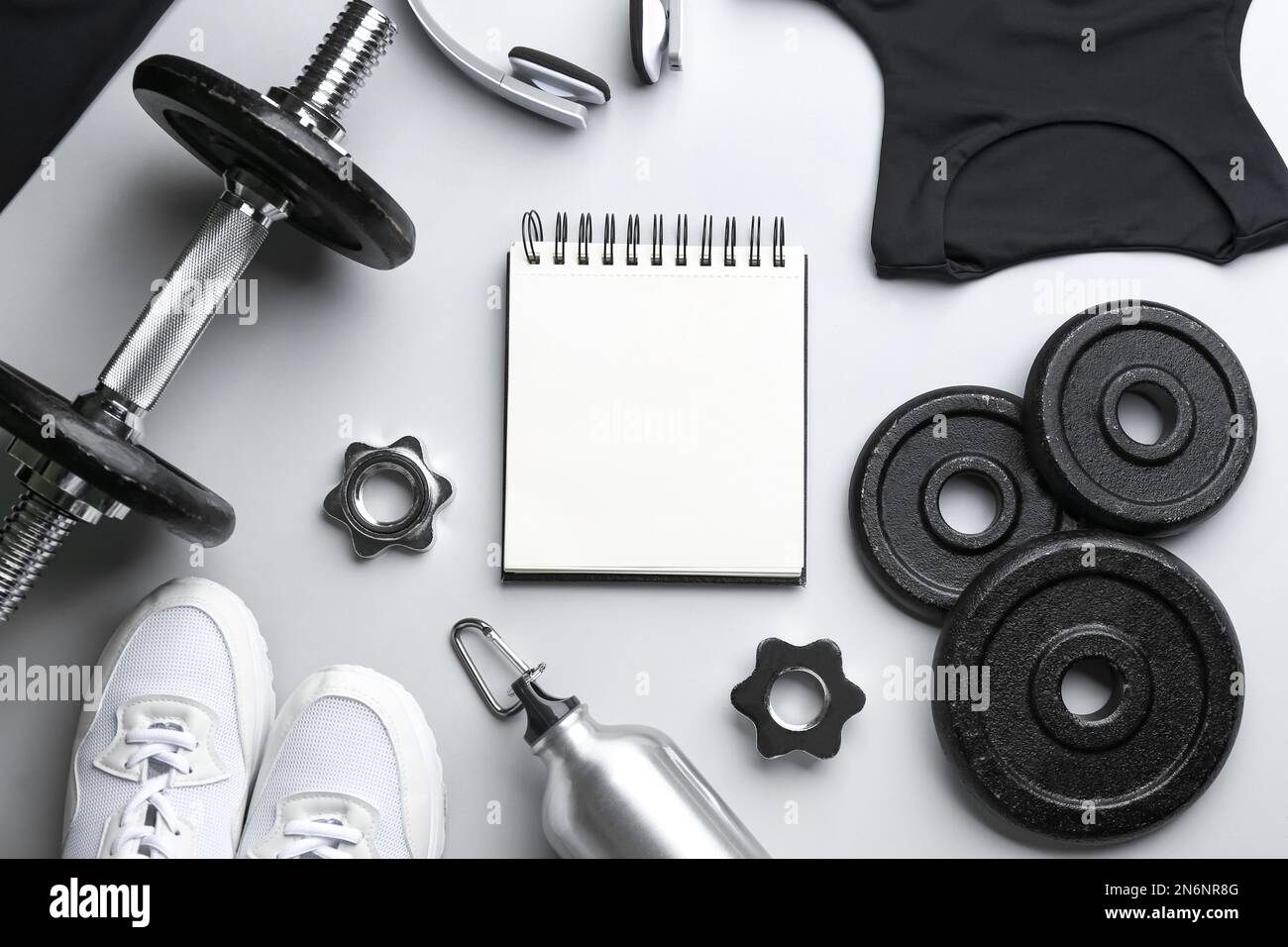 Flat lay composition with sportswear, notebook and equipment on light ...