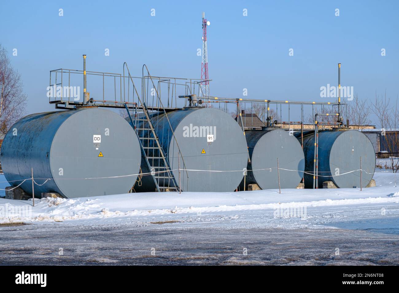 Four fuel storage tanks of different sizes in small farming Stock Photo ...