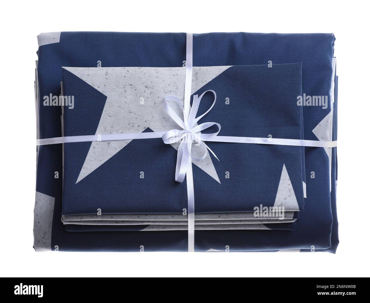 Stack of clean bed linens isolated on white, top view. Child's room ...