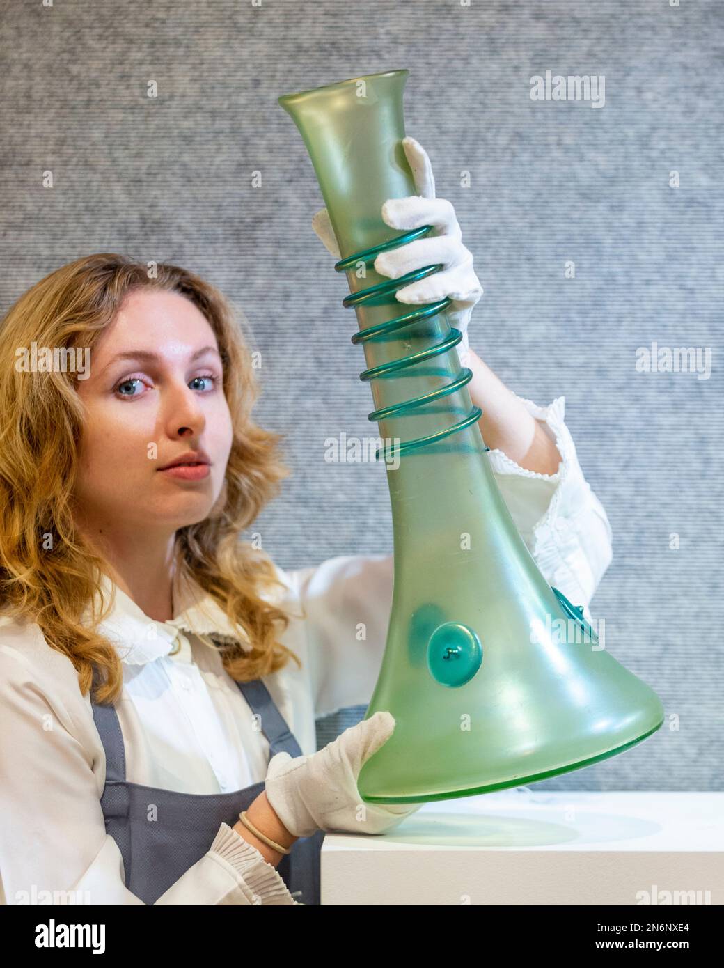 London, UK. 10 February 2023. A technician presents a Tall iridescent ...