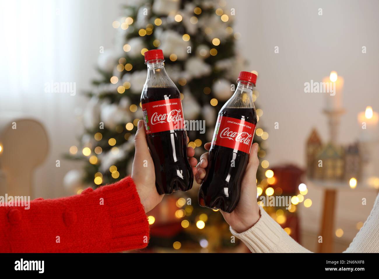 MYKOLAIV, UKRAINE - January 01, 2021: Women with bottles of Coca-Cola ...