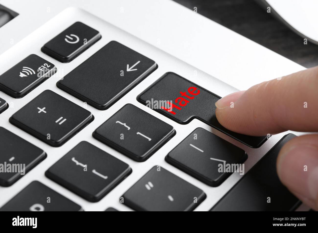 Woman pressing button with text Hate on computer keyboard, closeup ...