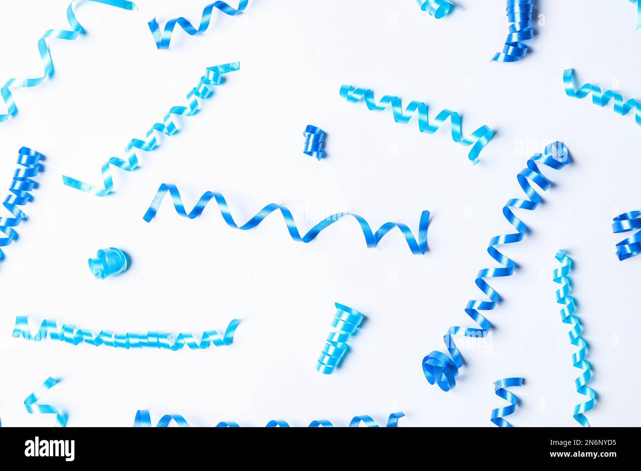 Blue serpentine streamers on white background, top view Stock Photo - Alamy