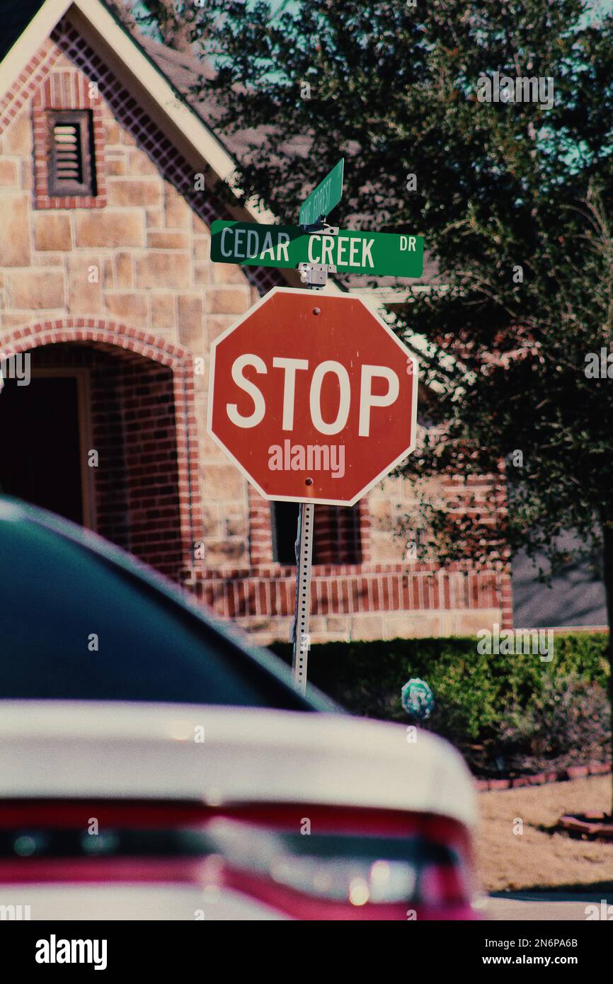 A vibrant image of a red octagonal stop sign with a brick building in ...
