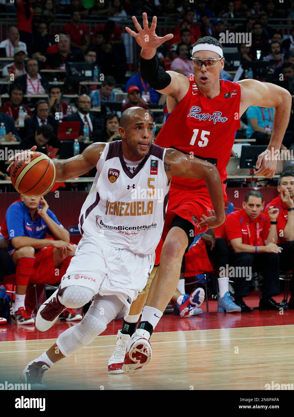 Venezuela's Gregory Vargas, left, dribbles the ball down court under ...