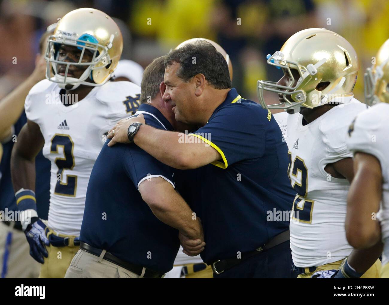 Michigan head coach Brady Hoke, right, hugs Notre Dame Fighting coach ...