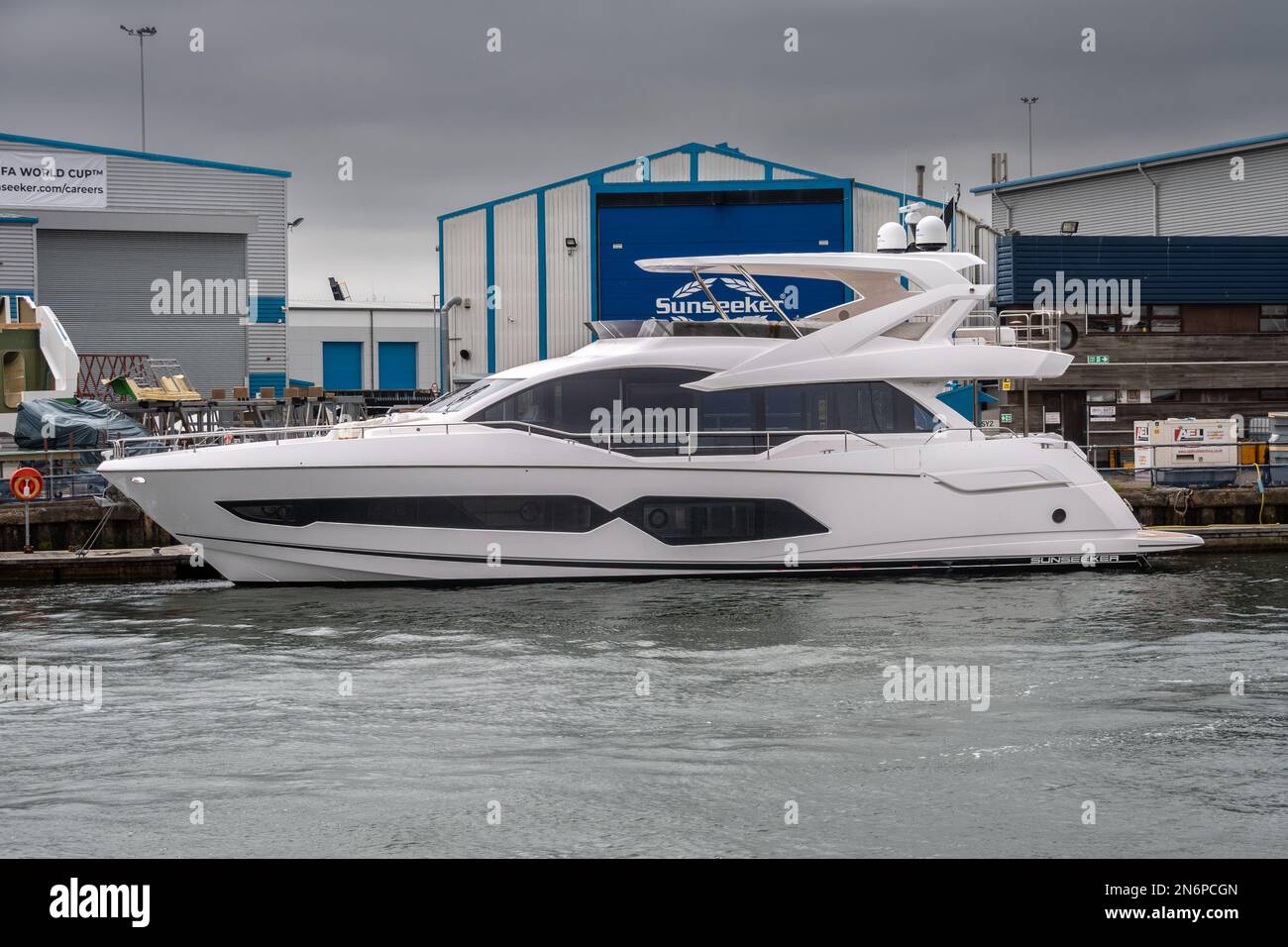 A Sunseeker 76 Yacht moored in front of the main assembly facility and ...