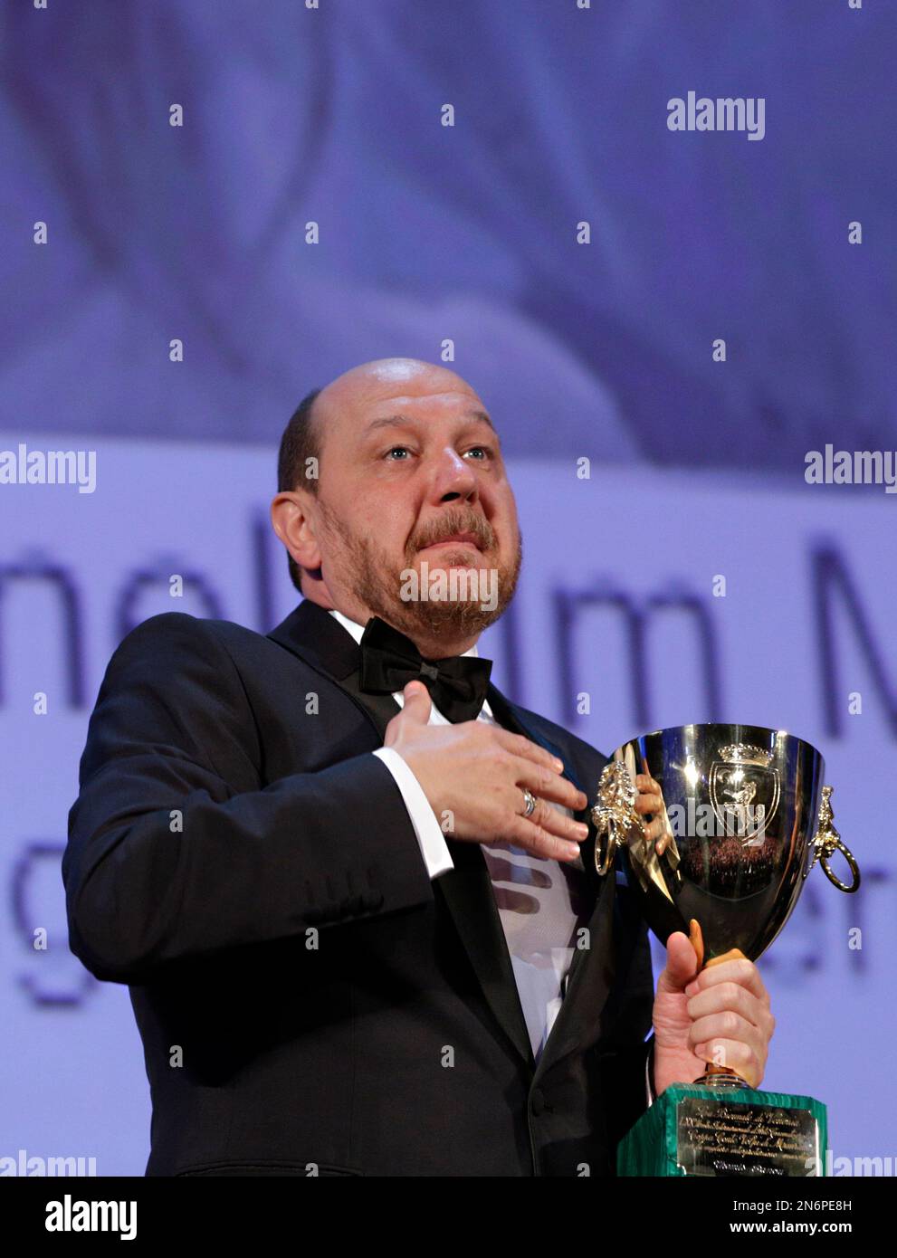Actor Themis Panou holds his Volpi Cup for Best Actor for his role in ...
