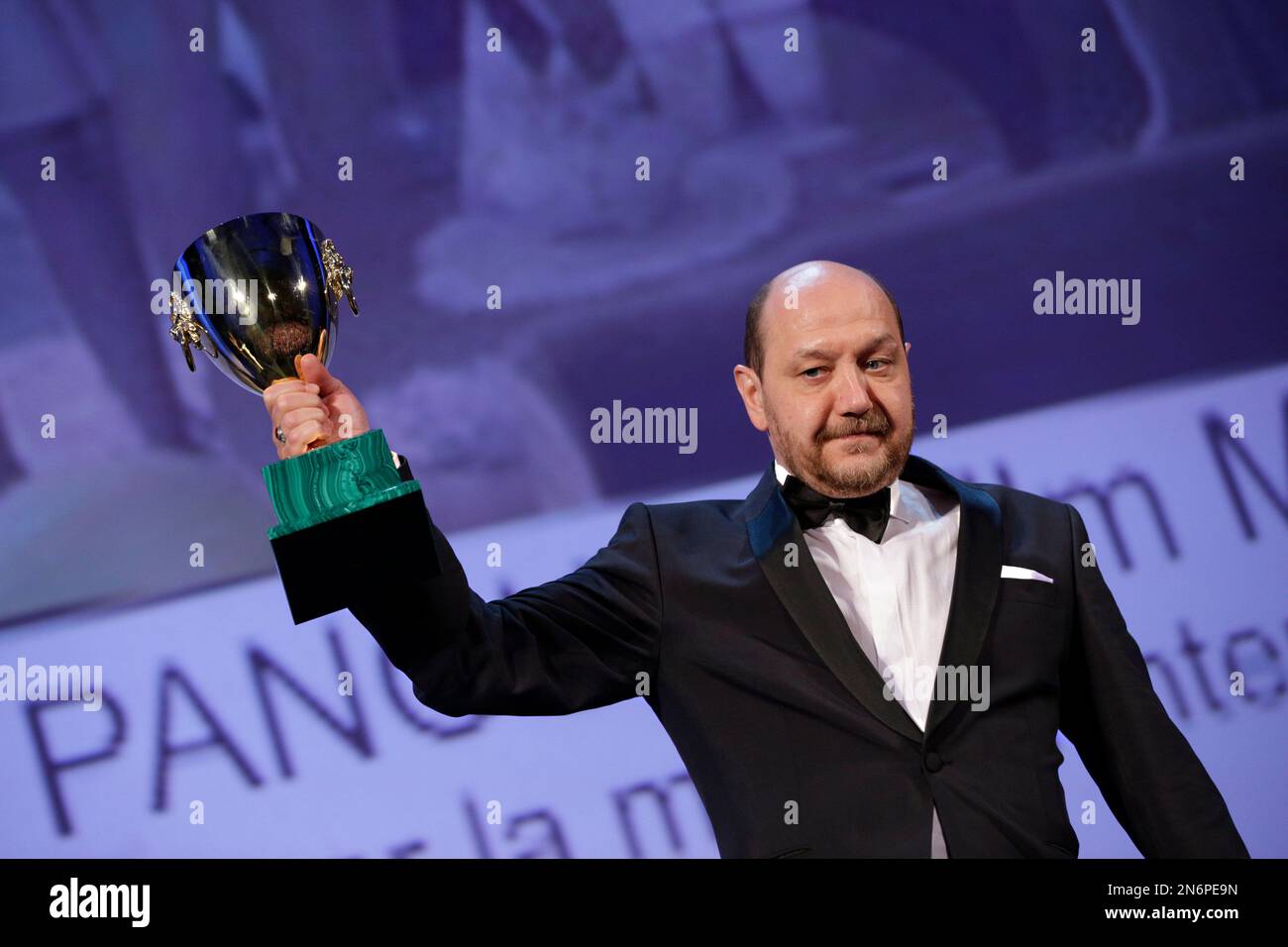 Actor Themis Panou holds his Volpi Cup for Best Actor for his role in ...