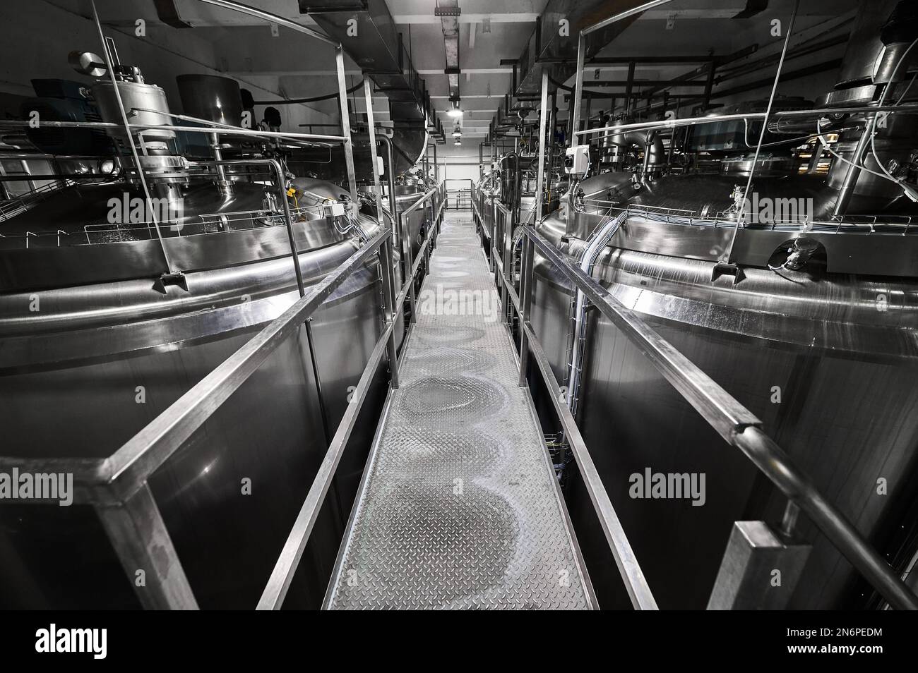 Metal ground near large cisterns for fermented milk products Stock ...