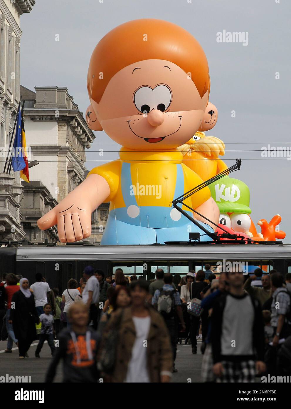 A tram passes a giant inflatable comic strip character during the ...
