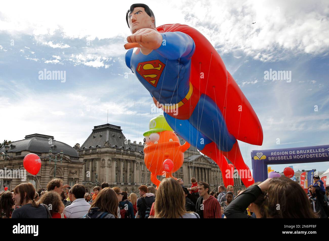 A giant inflatable Superman flies past the Royal Palace, during the ...