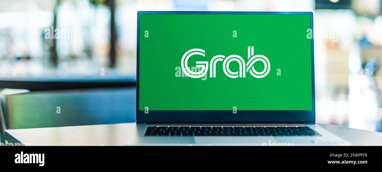 POZNAN, POL - JUN 28, 2022: Laptop computer displaying logo of Grab ...