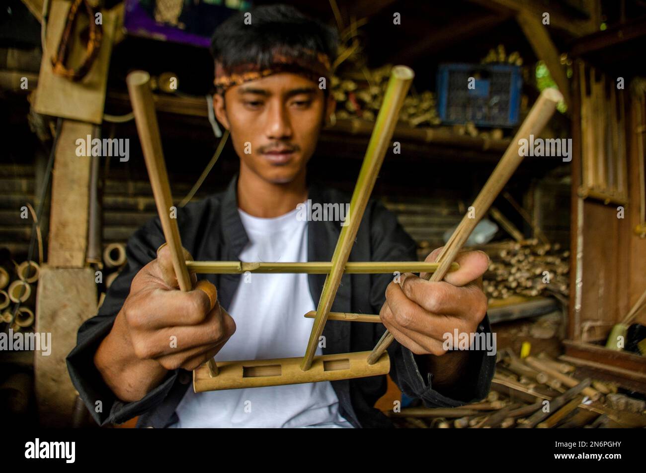 Bandung, Indonesia. 10th Feb, 2023. A worker makes an angklung, a ...