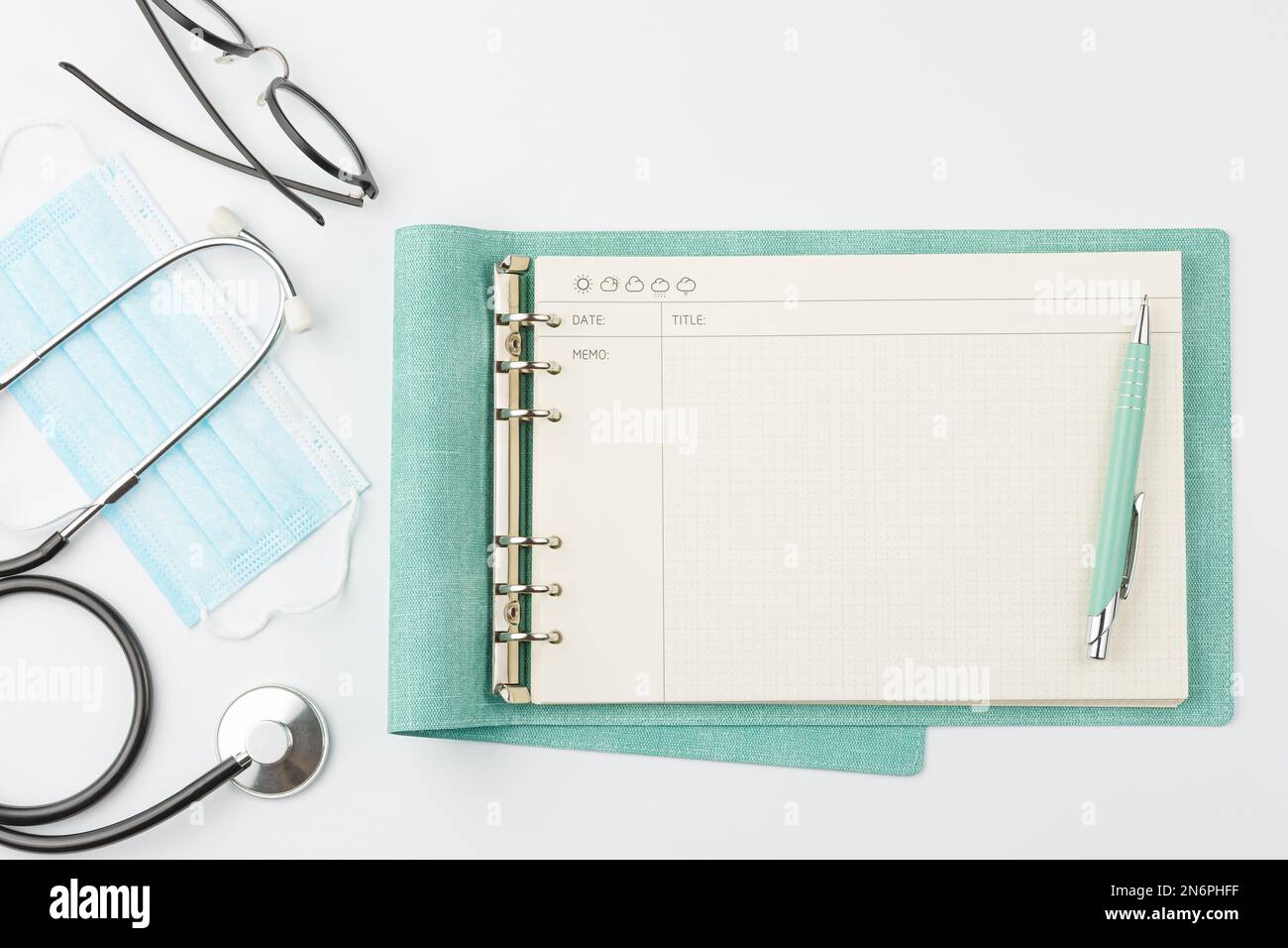 Doctor desk. Notebook with stethoscope and mask Stock Photo - Alamy