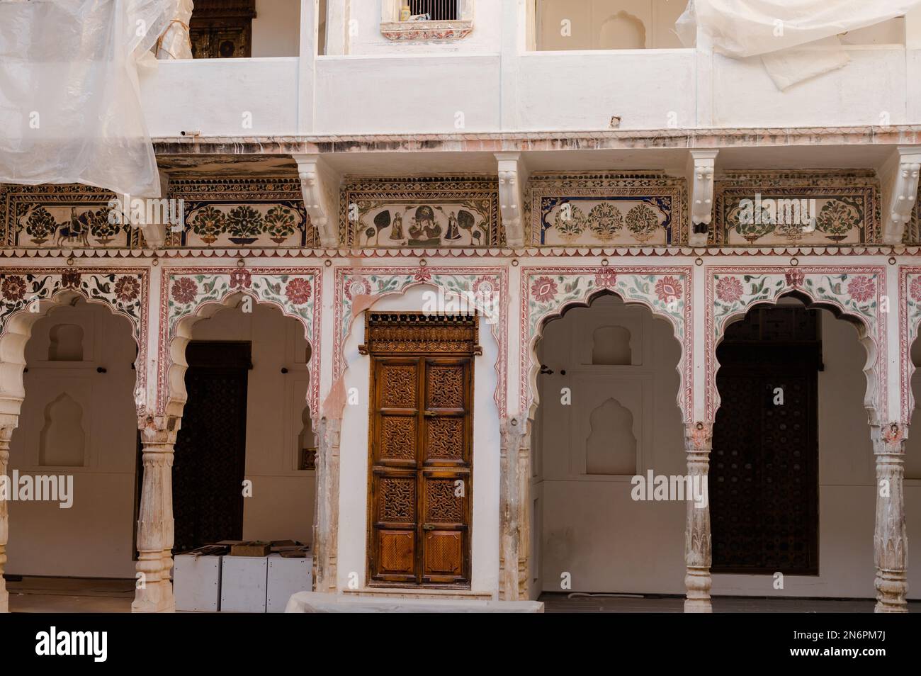 An exterior view of a Haveli house, the wooden doors with carvings in ...