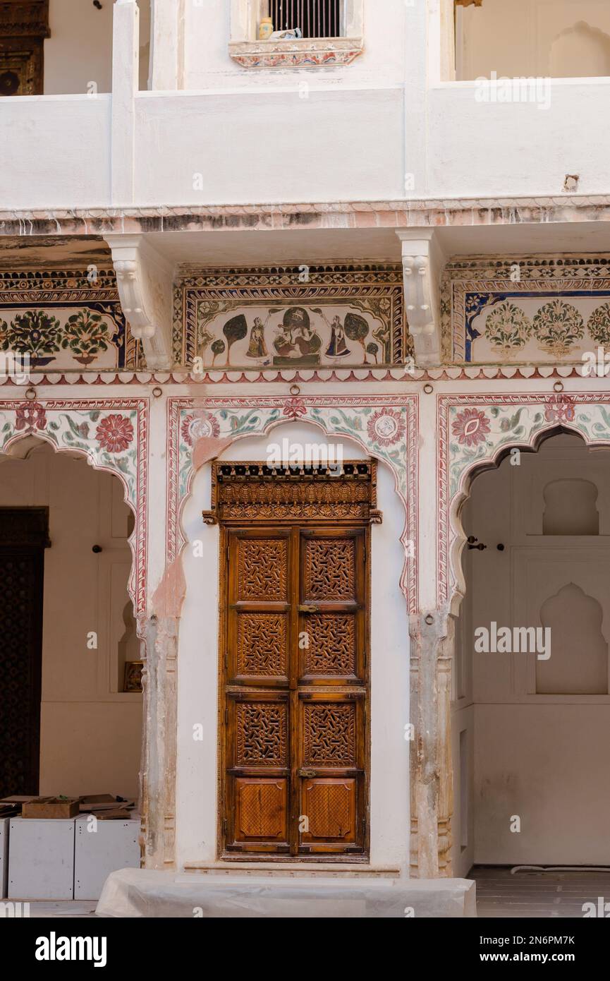 A vertical of a Haveli house, the wooden doors with carvings in Mandawa ...