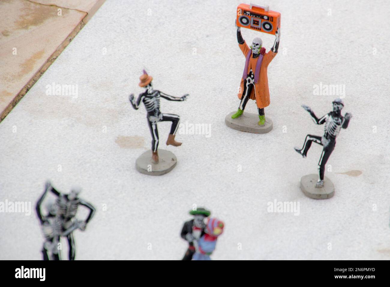 A close-up shot of dancing miniature figurines of skeletons Stock Photo ...