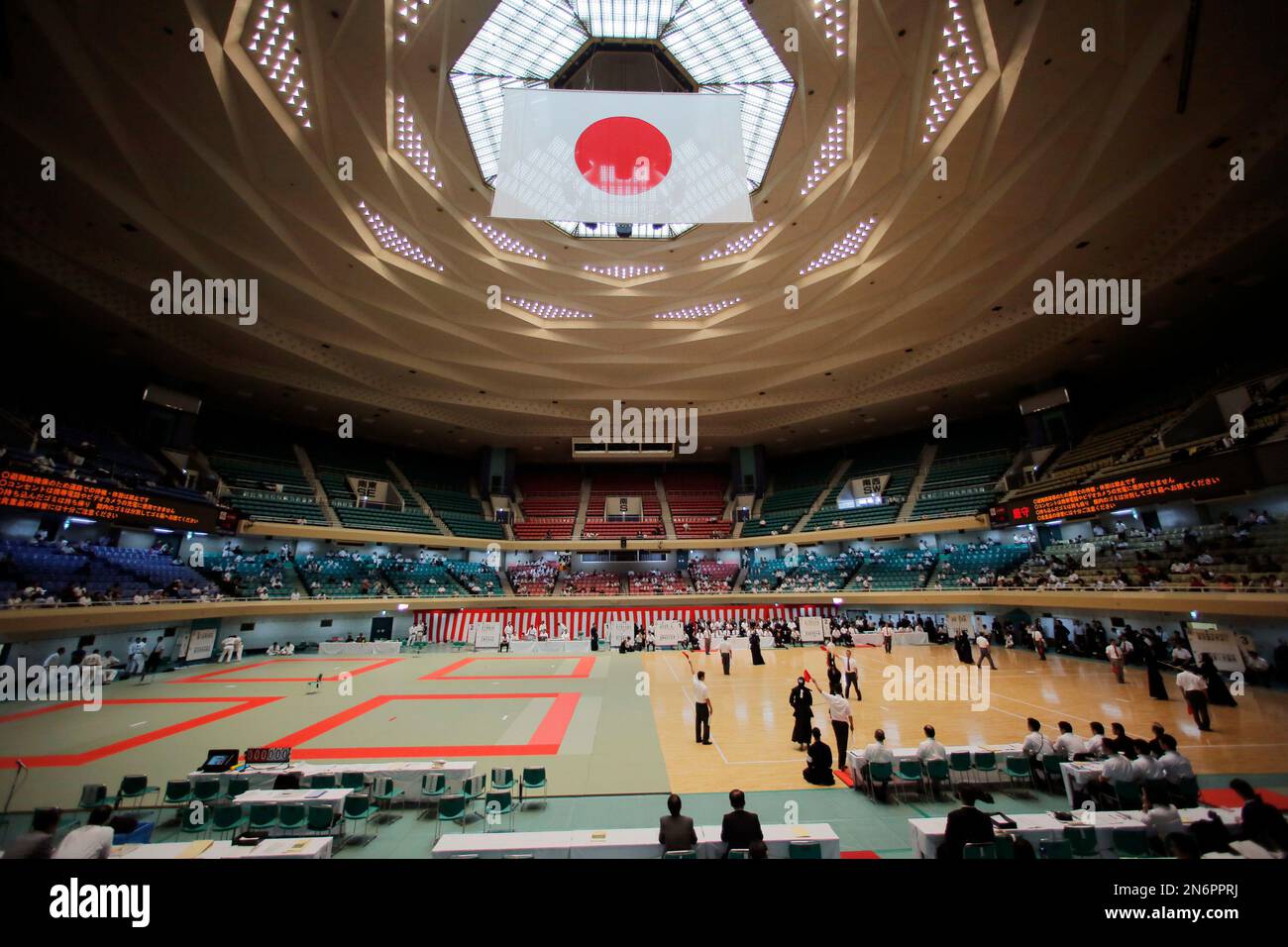 Under a Japanese flag, police officers compete in a Kendo tournament at ...
