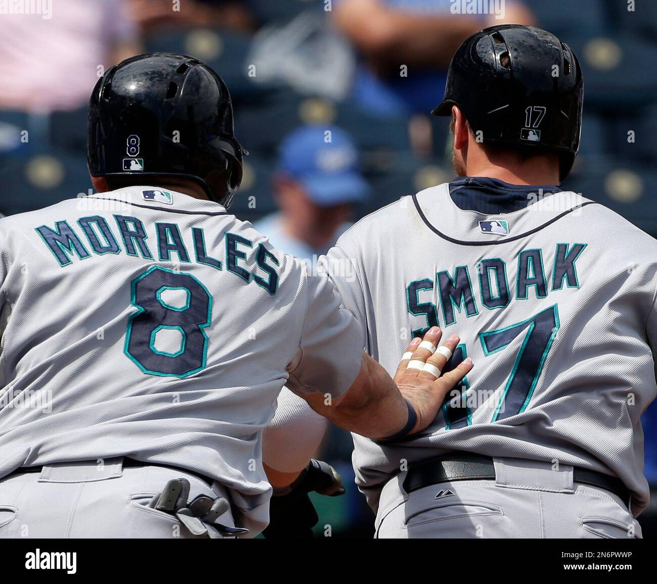 Seattle Mariners' Justin Smoak (17) is congratulated by Kendrys Morales ...