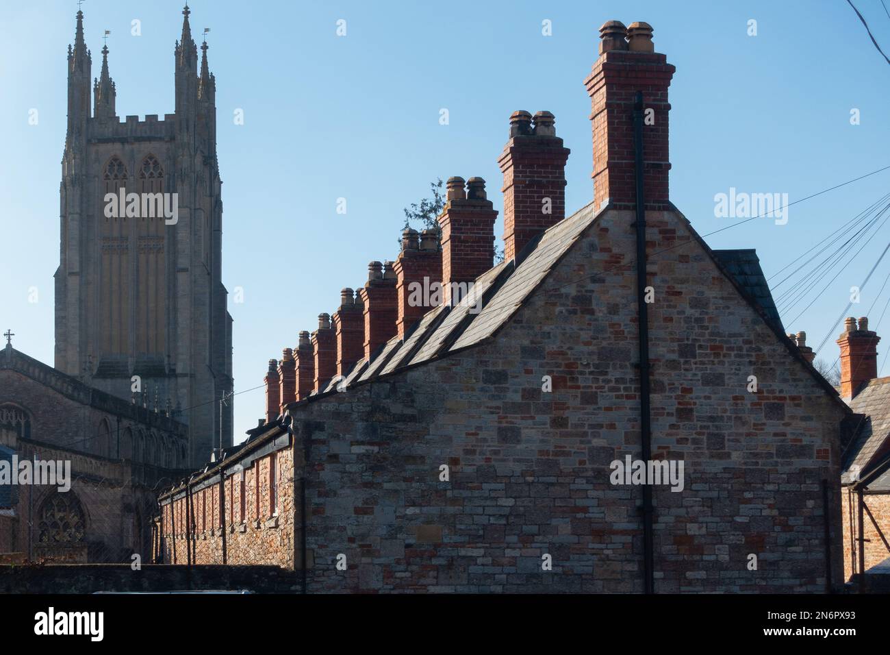 Alms houses' chimneys with St Cuthbert's church tower, Wells, Somerset ...