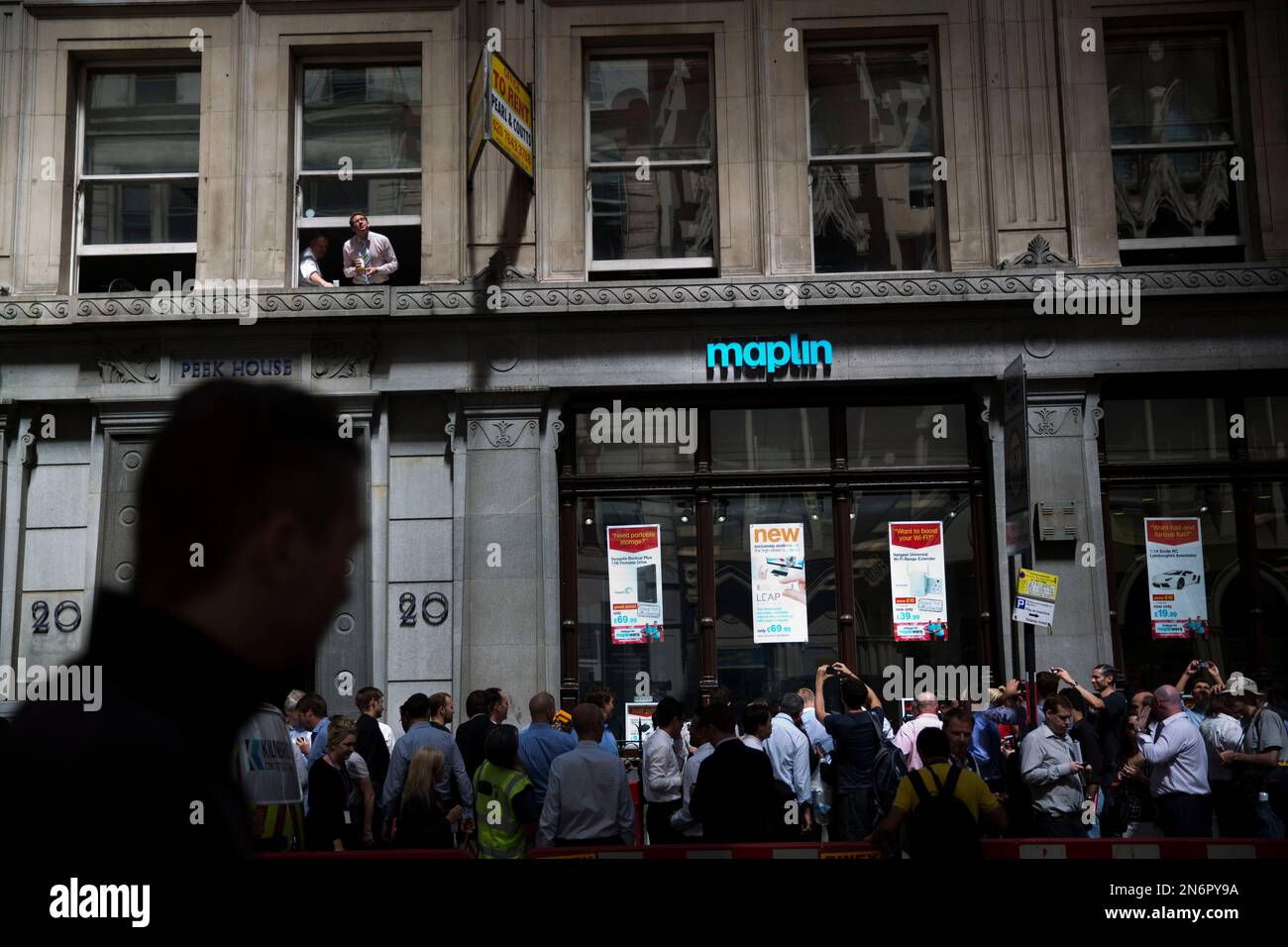 People gather round to see the saddle of a bike that melted and was ...