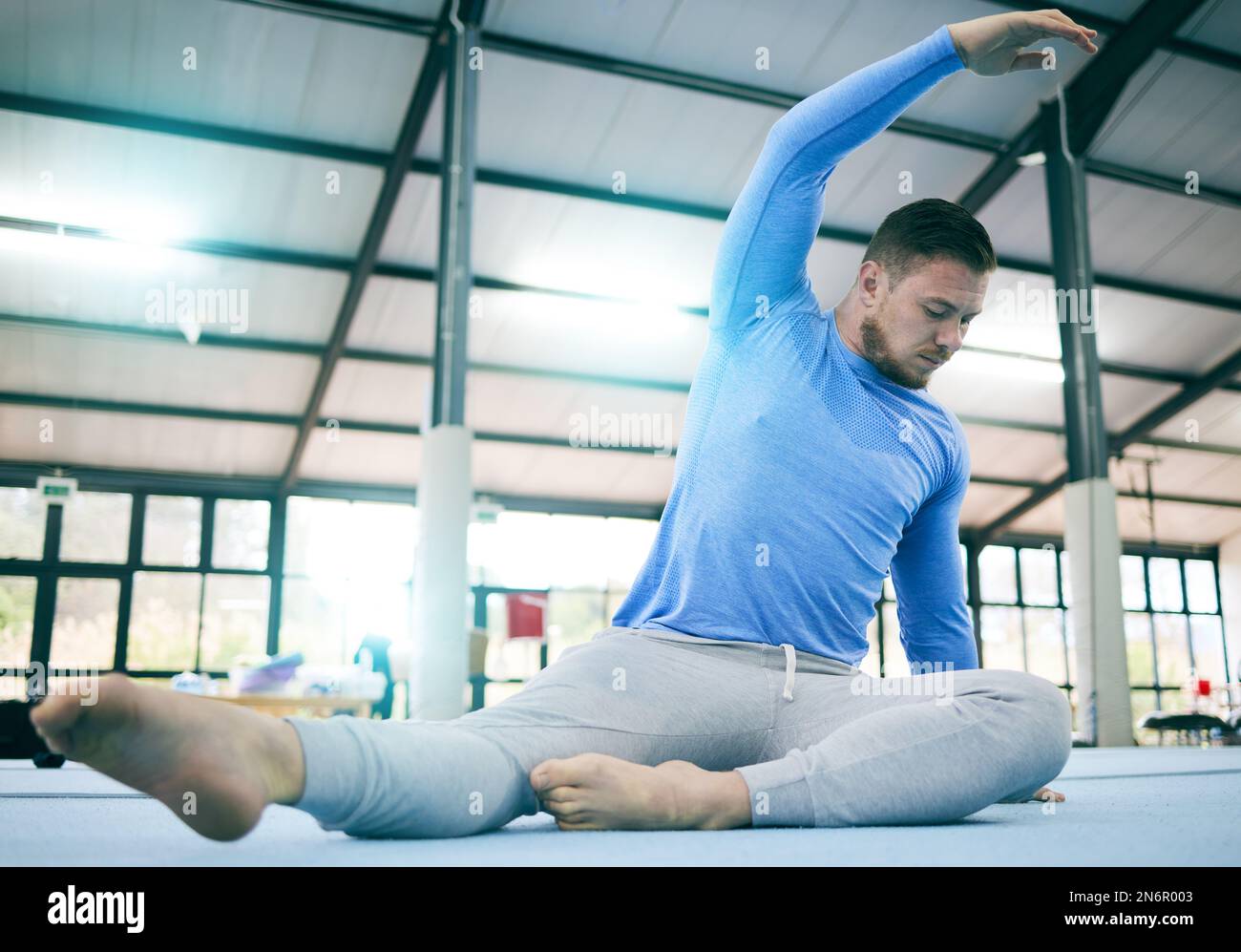 Sports, gymnastics and man stretching body ready to start warm up for ...